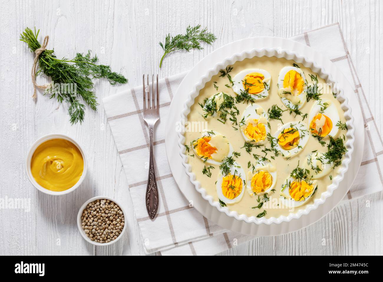 Senfeier, hard boiled eggs in rich creamy mustard sauce in white baking ...