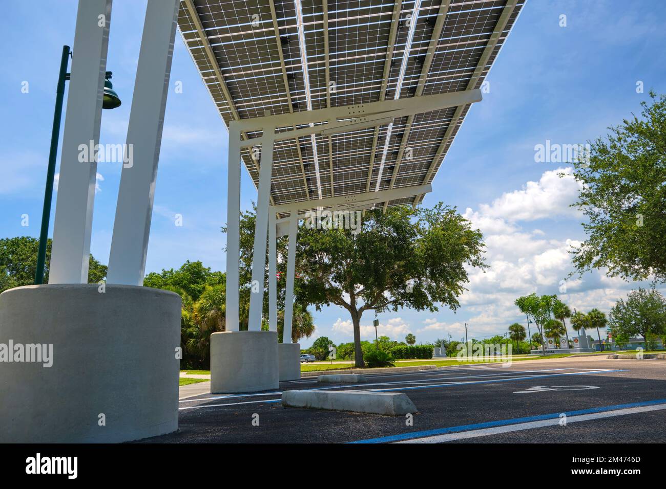 Solar panels installed over parking lot canopy shade for parked cars ...