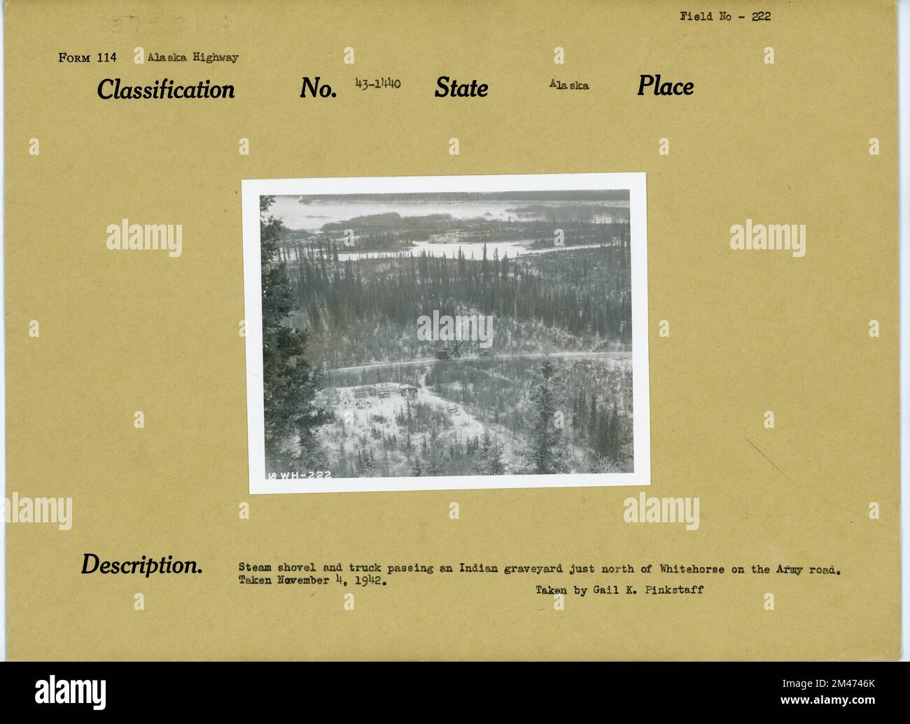 Steam shovel and truck passing an Indian graveyard. Original caption ...