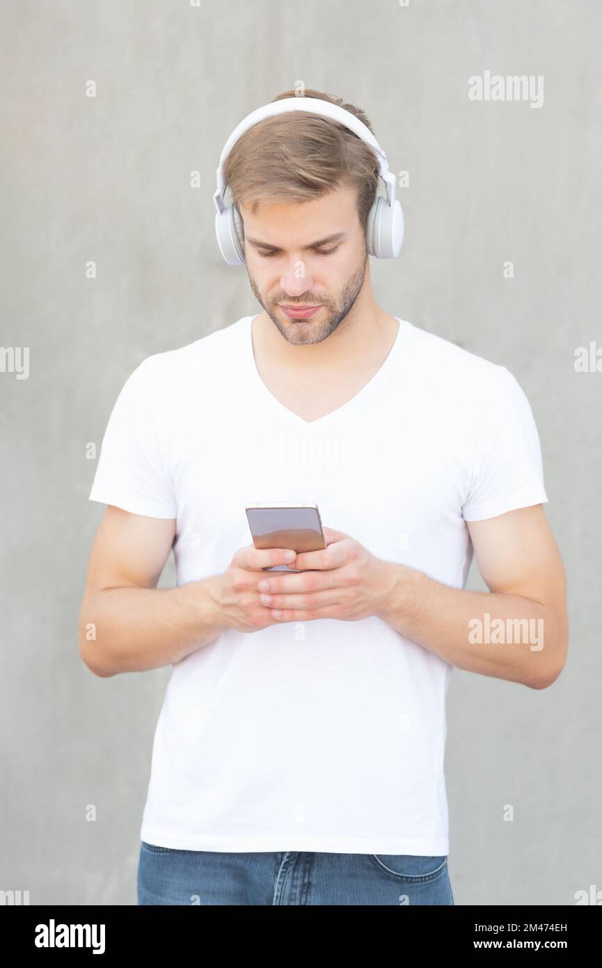 photo of man mp3 music playlist in headphones. man open mp3 music ...