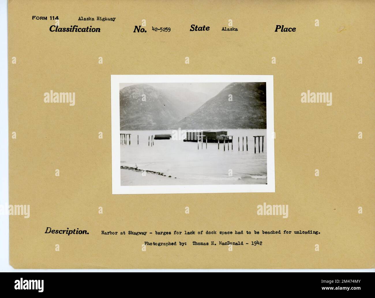 Building Alaska Highway. Original caption: Harbor at Skagway - barges ...
