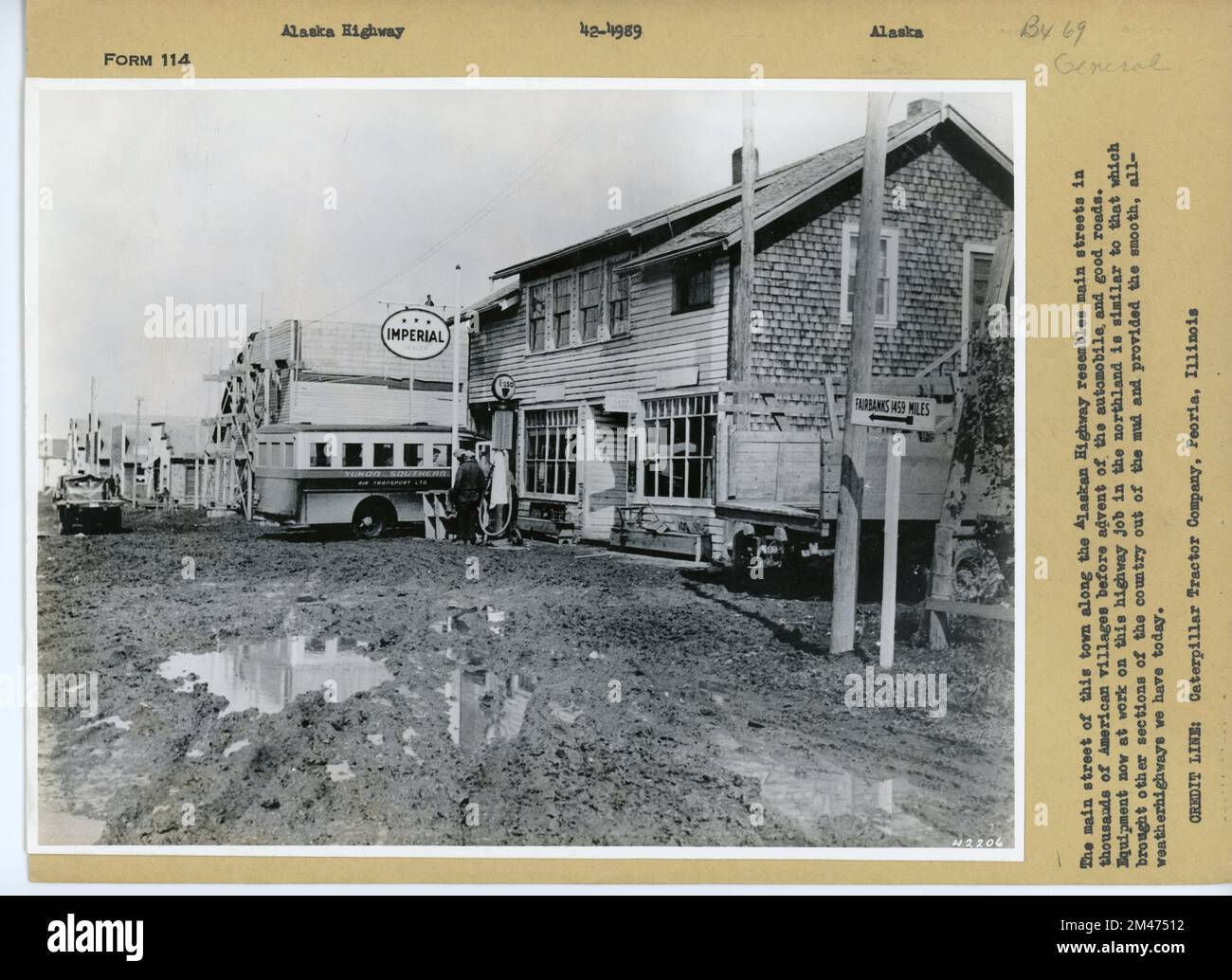 Building Alaska Highway. Original caption: The main street of this town ...