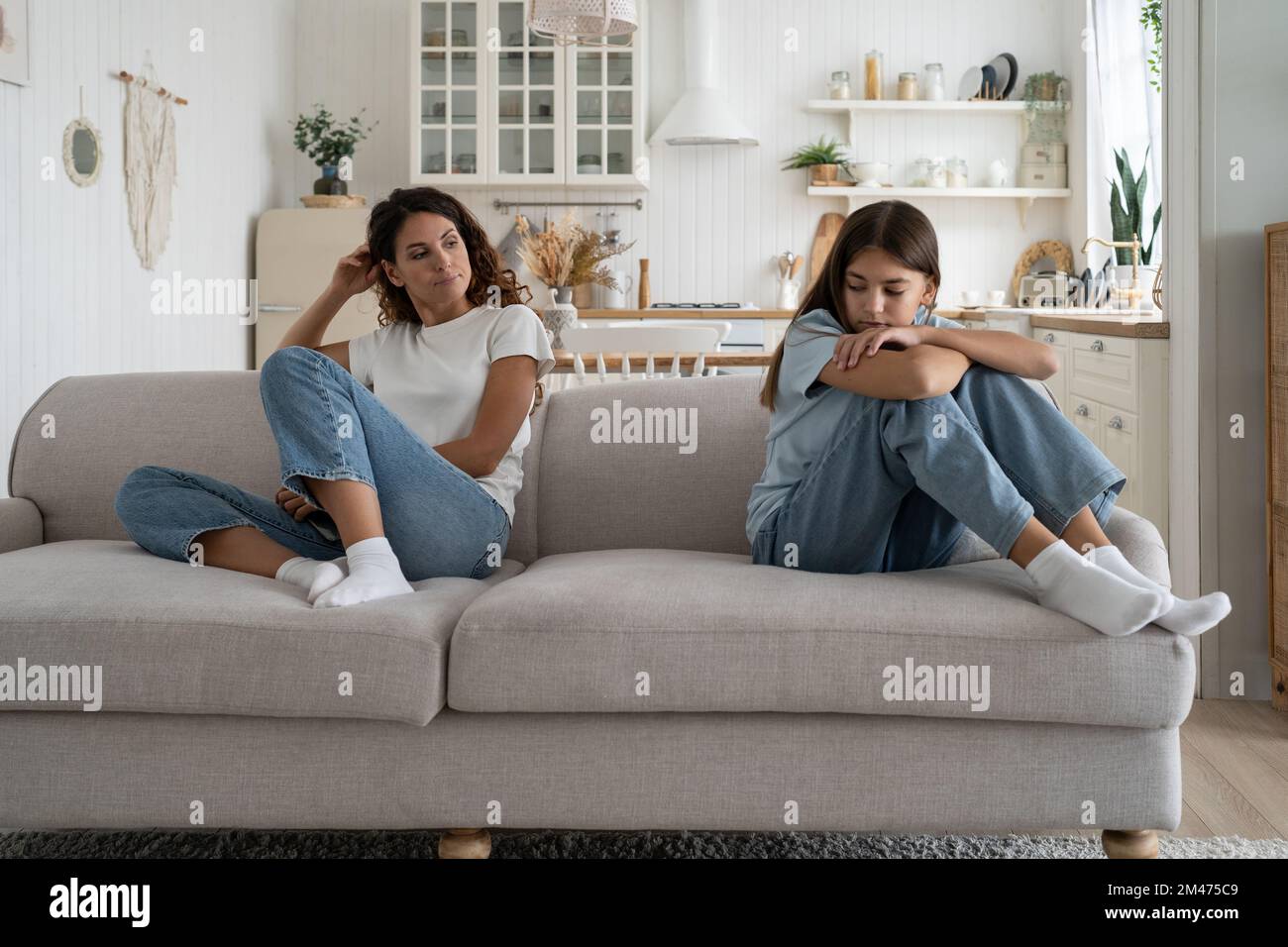 Upset frustrated mother and teenage daughter ignoring each other after quarrel at home Stock ...
