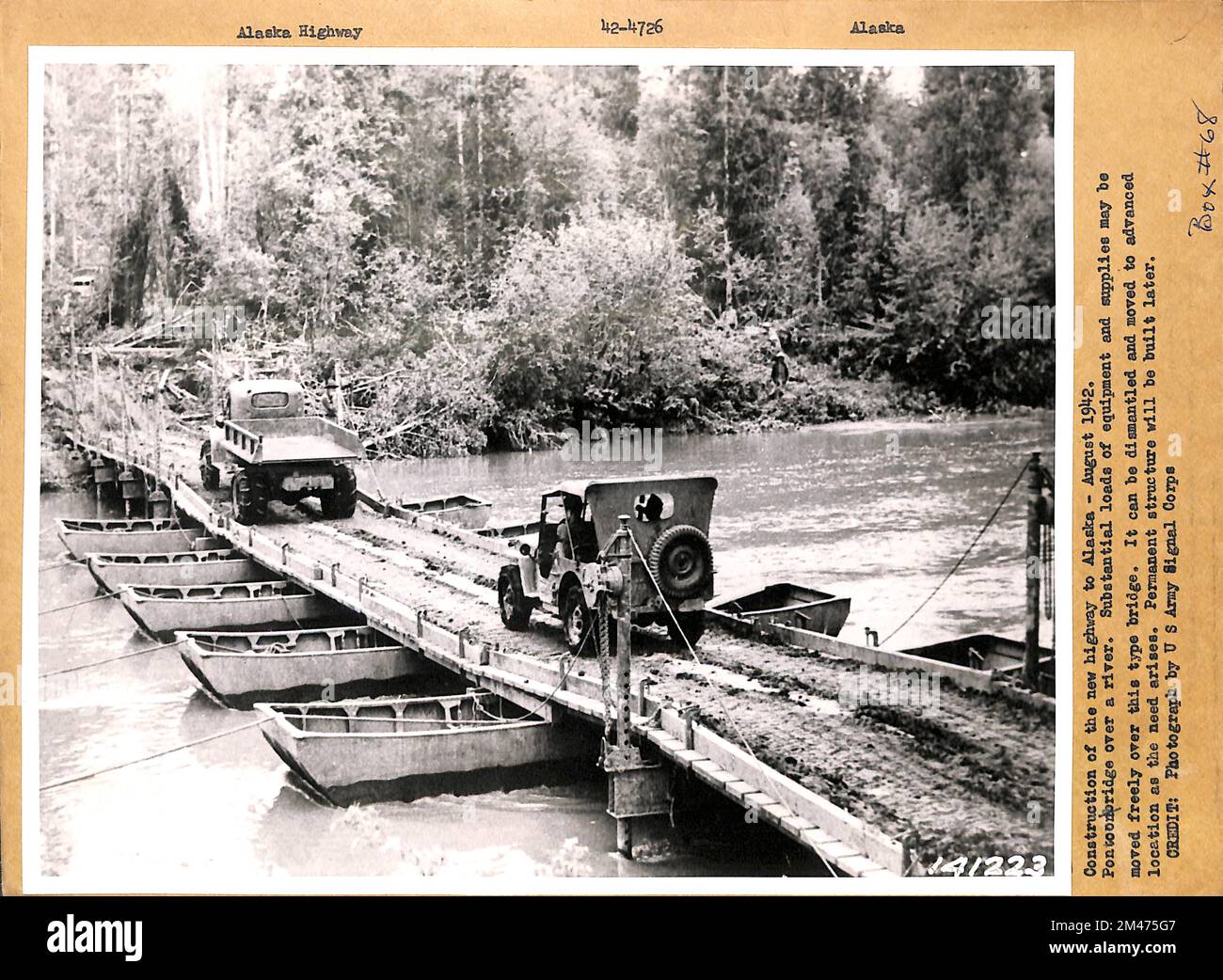 Pontoon bridge over a river. Original caption: Construction of the new ...