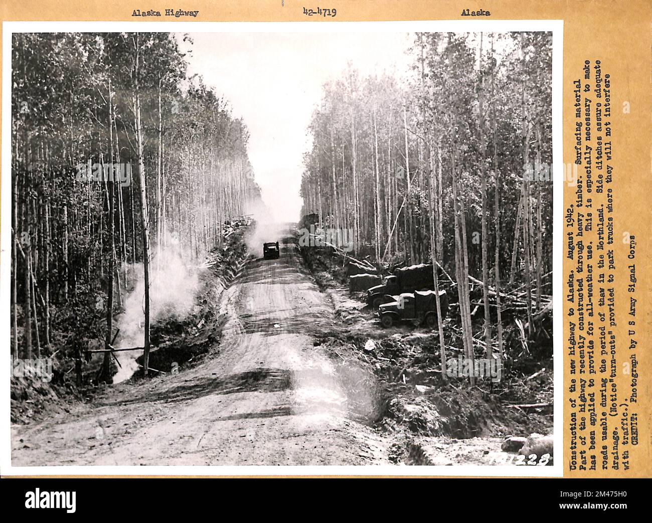 Part of the highway recently constructed through heavy timber. Original ...