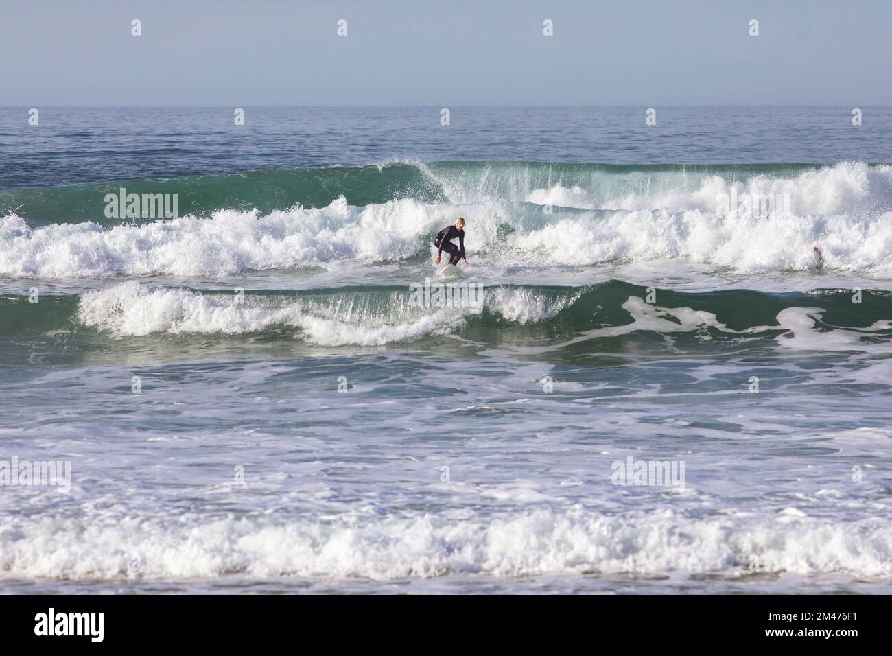 Portugal, Oeste Region, Ferrel, Praia da Almagreira, Surfer riding a ...