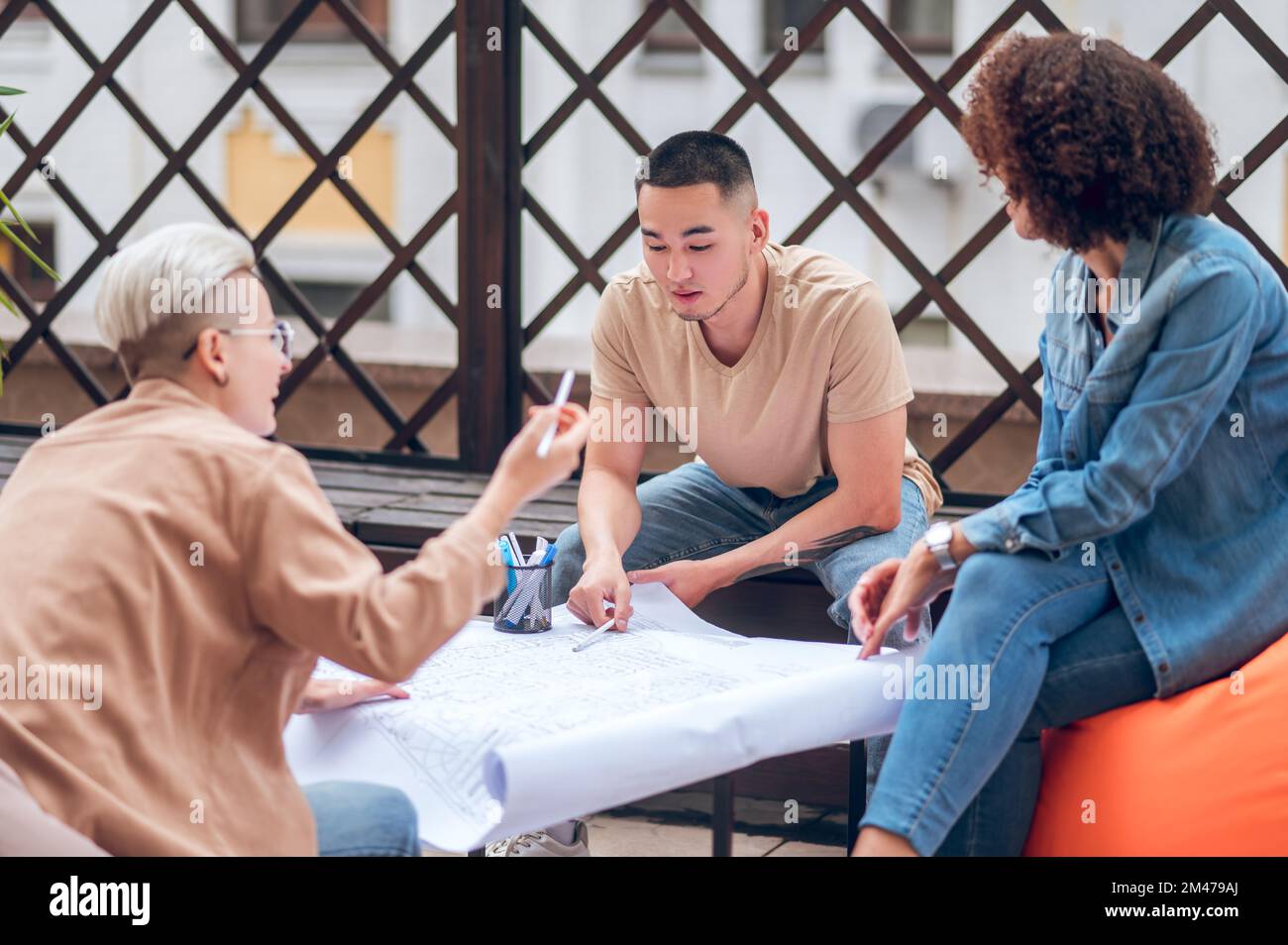 Design professionals working on a construction drawing Stock Photo - Alamy