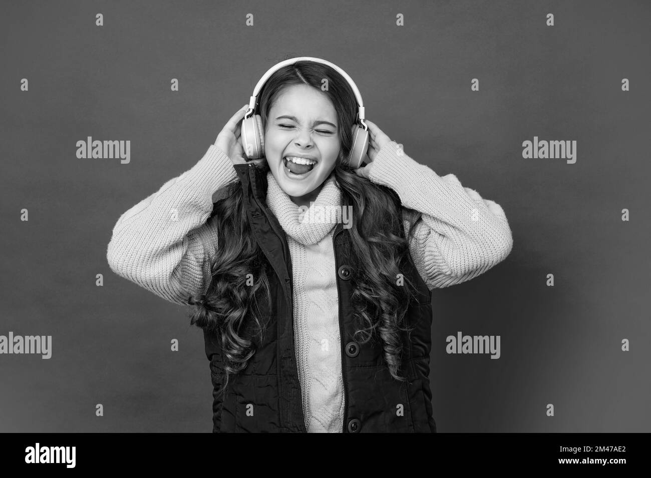 happy shouting teen girl in hat and earphones. modern life in childhood ...