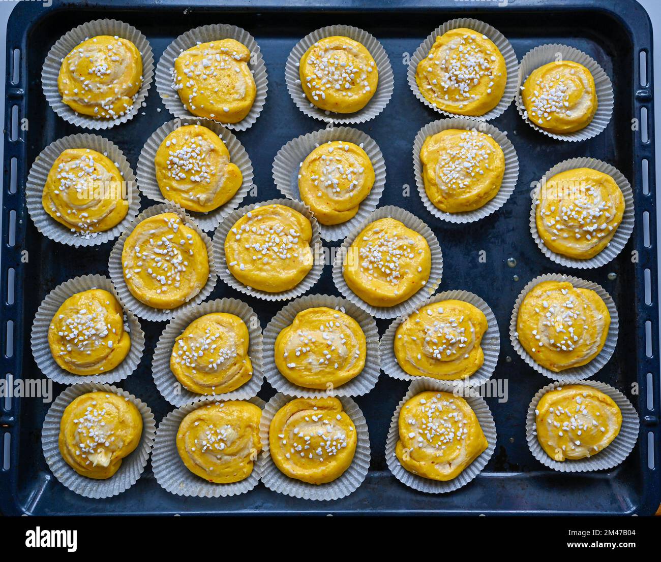Yellow saffron buns with suger sprinkled on Stock Photo - Alamy