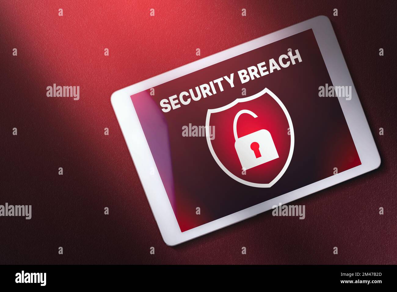 Digital Tablet On Red Background With Security Breach Warning On Screen Interface Of Security