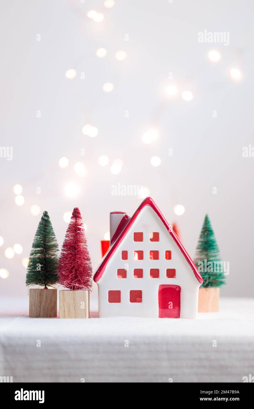 Ceramic christmas miniature house with spruce on the white background ...