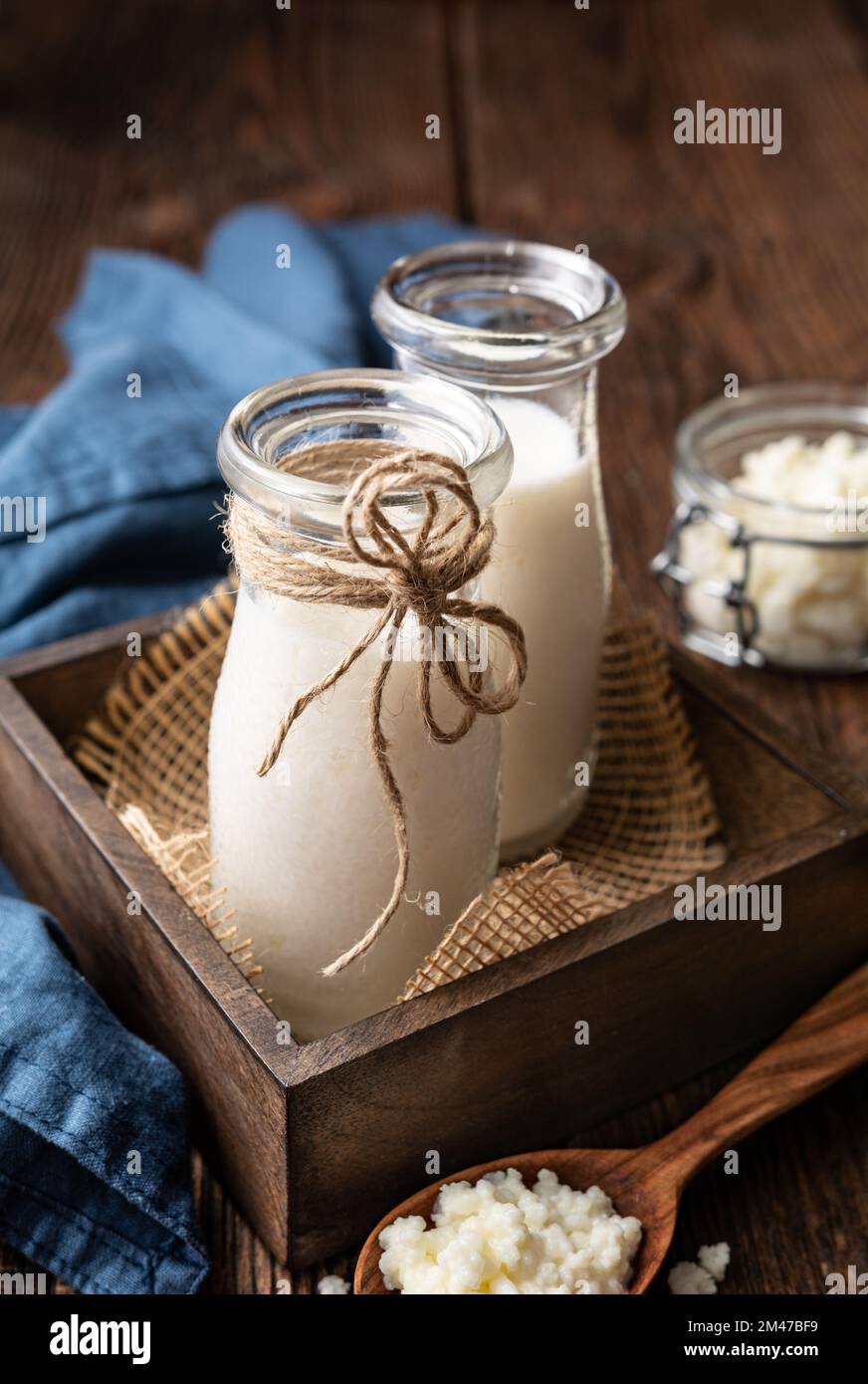 Kefir, healthy probiotic beverage with milk kefir grains on wooden ...