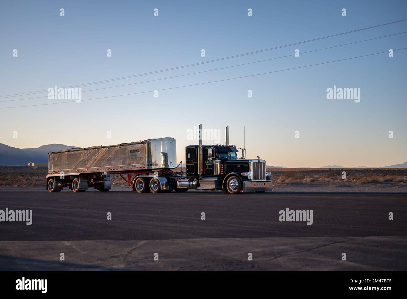 American Peterbilt long nose truck with a large trailer driving on the ...