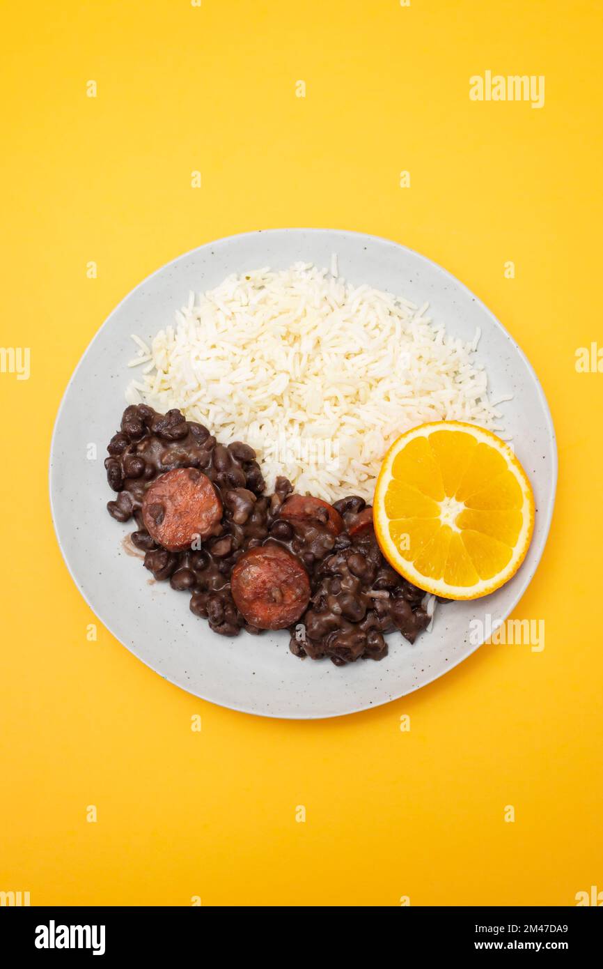 Typical brazilian food beans with sausages and rice Feijoada on white ...