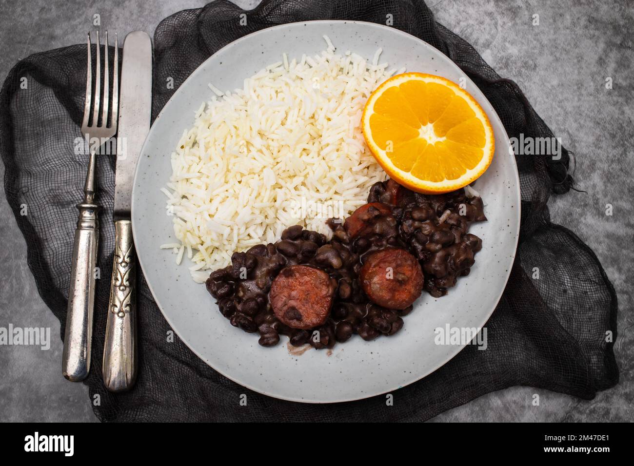 Typical brazilian food beans with sausages and rice Feijoada on white ...