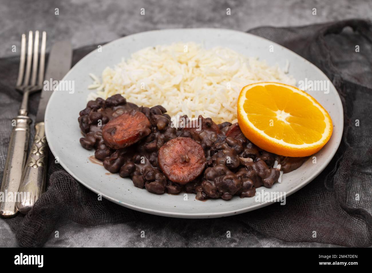 Typical brazilian food beans with sausages and rice Feijoada on white ...