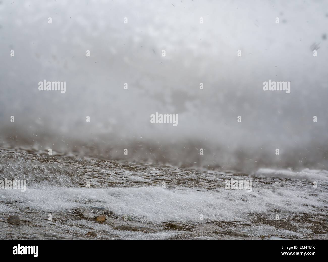 Focus stacked ground level view of ice accumulation on a sidewalk with ...