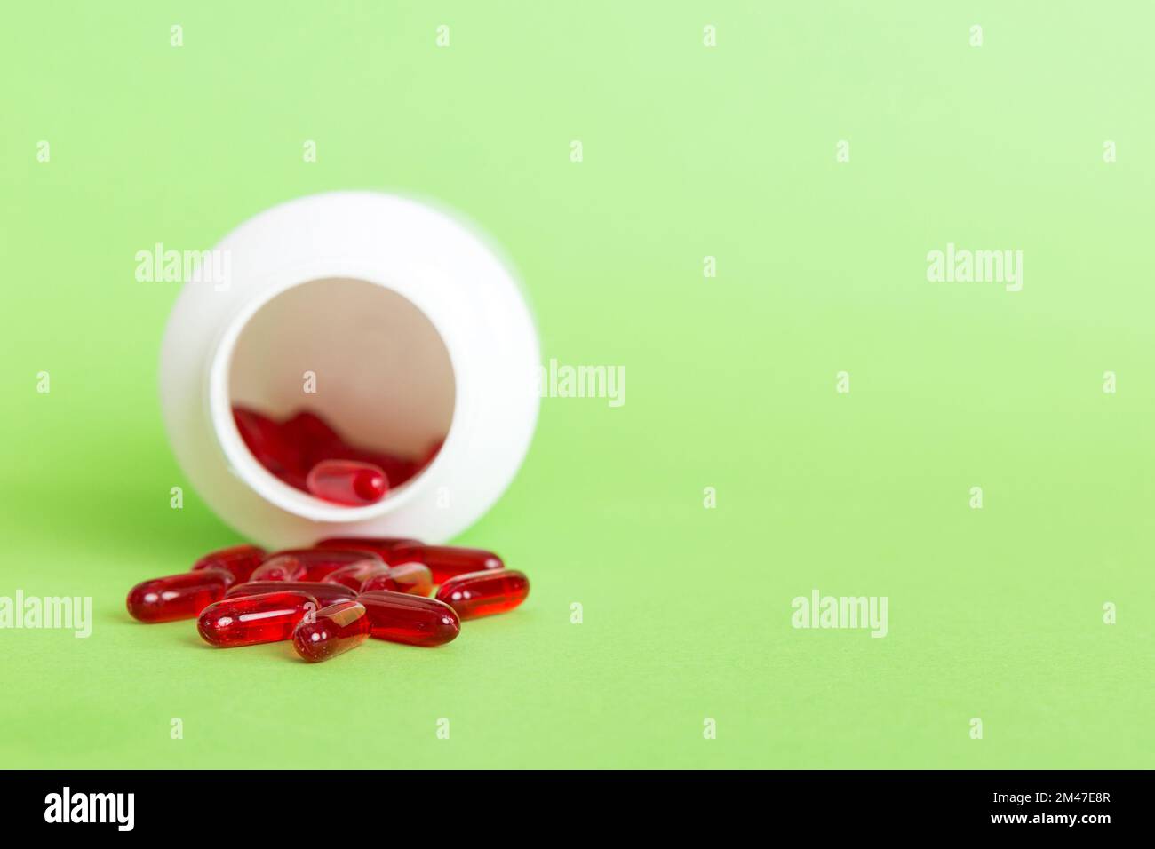 Red pills spilled around a pill bottle. Medicines and prescription ...