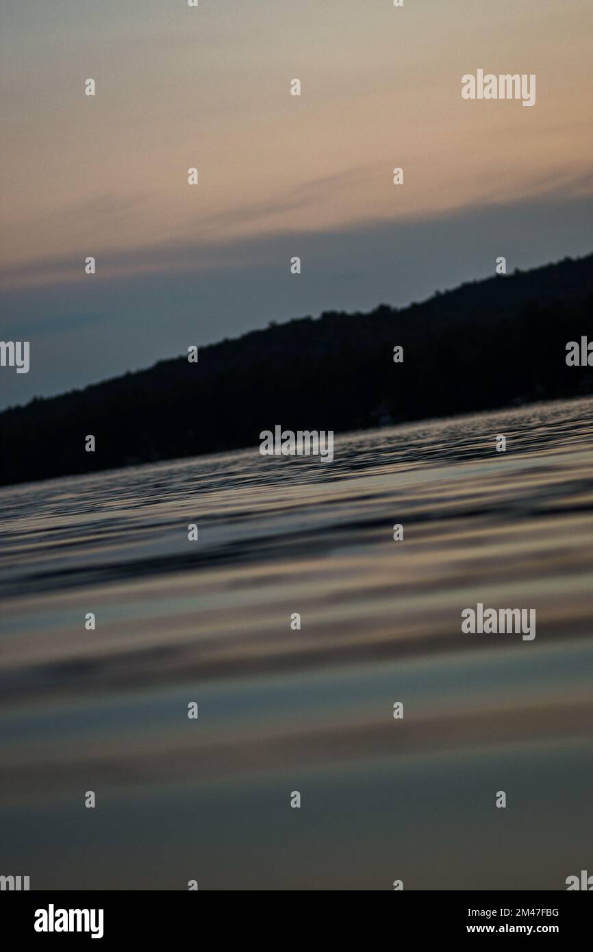 Calm waters and sunset colors on a Summer evening Stock Photo - Alamy