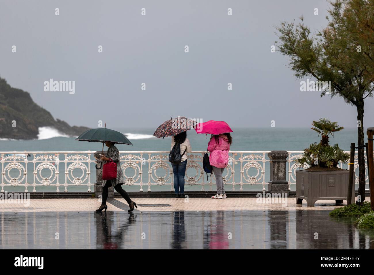 People walking under the rain with umbrellas in San Sebastian Stock ...