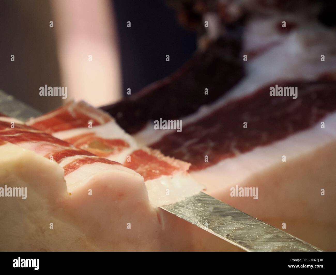 cutting spanish iberic cured ham detail Stock Photo - Alamy