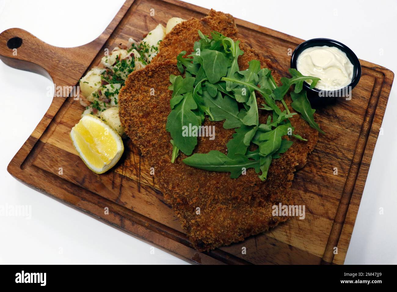 crumb fried veal chop known as schnitzel or milanese Stock Photo - Alamy