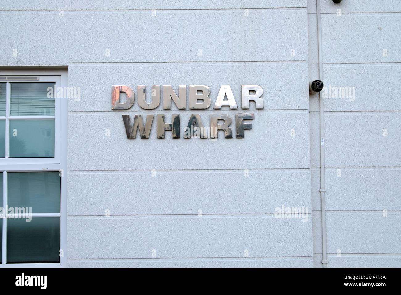 Dunbar Wharf sign on housing flats apartment building at Limehouse Hole ...