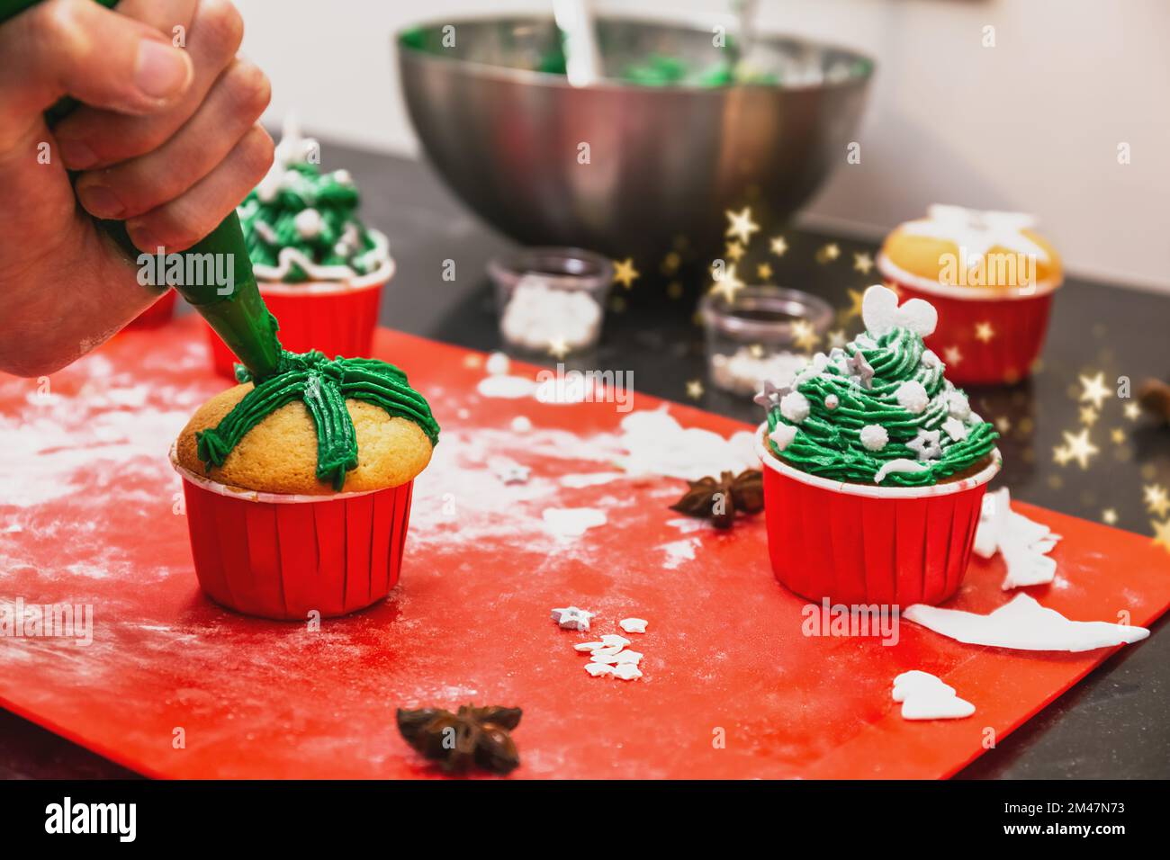 Baker making Christmas treat. Cupcakes shaped Christmas tree. Hands ...
