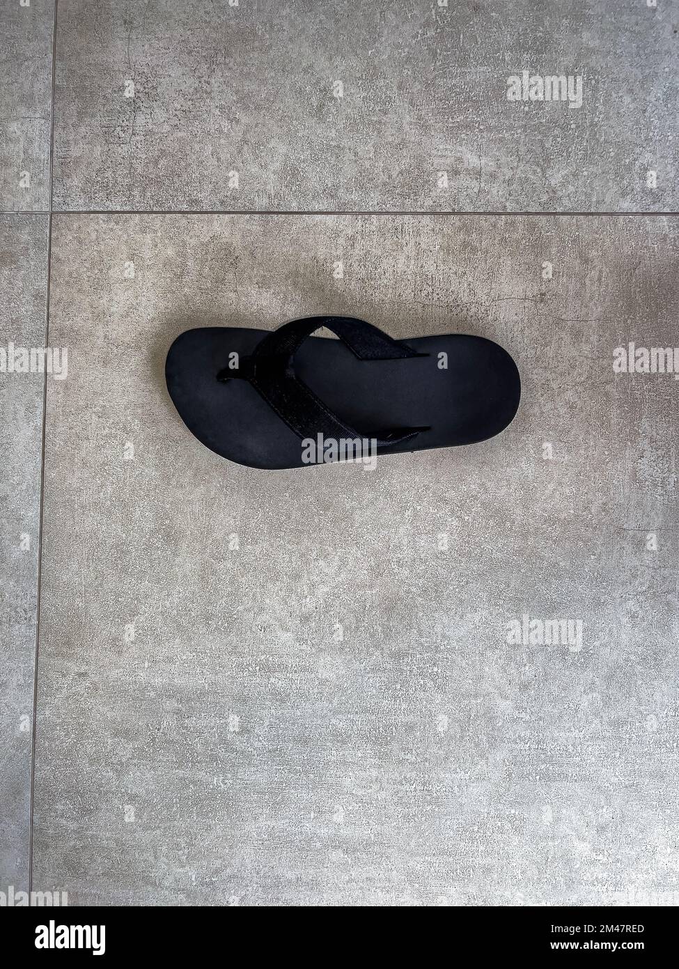 Old slippers on concrete background with copy space Stock Photo - Alamy
