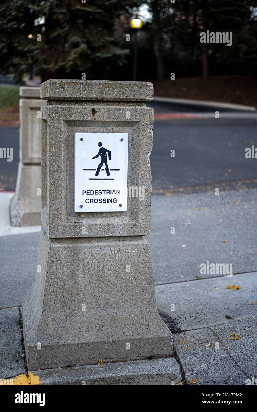 Pedestrian Crossing Caution Sign on a Pillar Stock Photo - Alamy