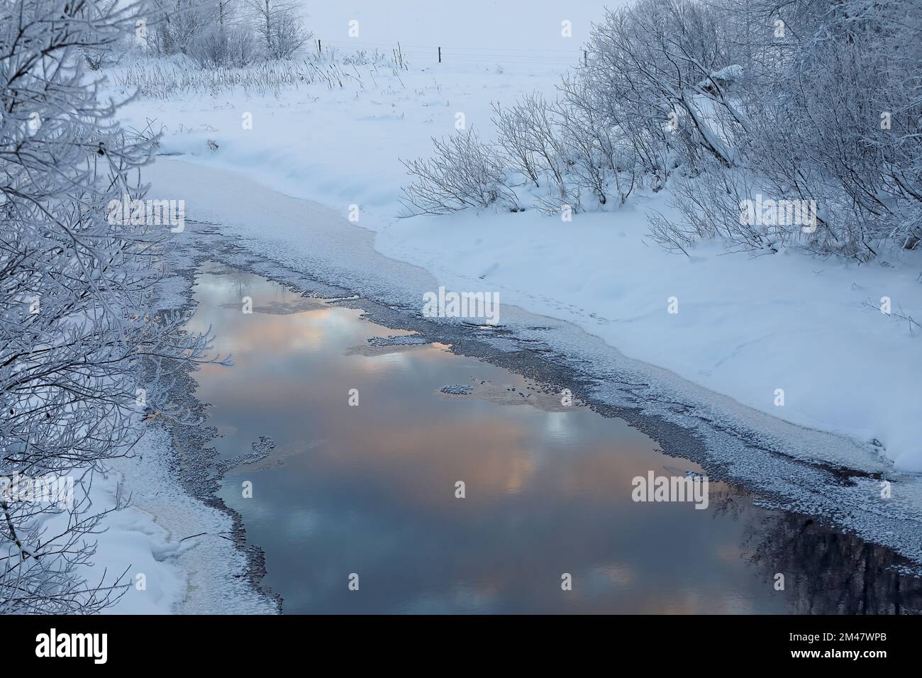 Edge of ice in the water with reflections of dark colors of sky Stock ...