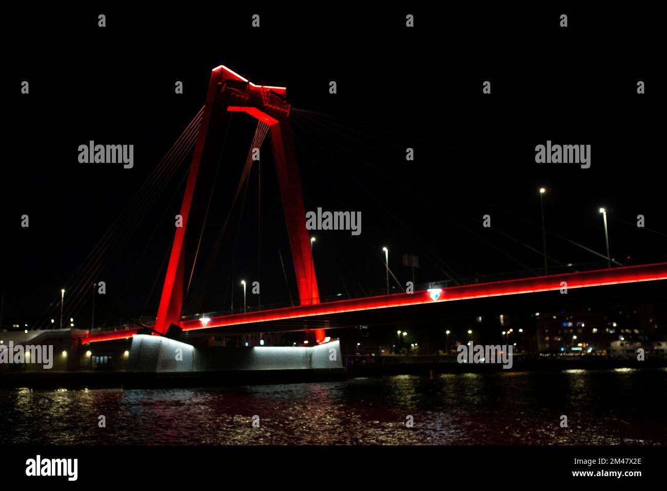 Night time urban scenery with steel draw bridge in glowing red in ...