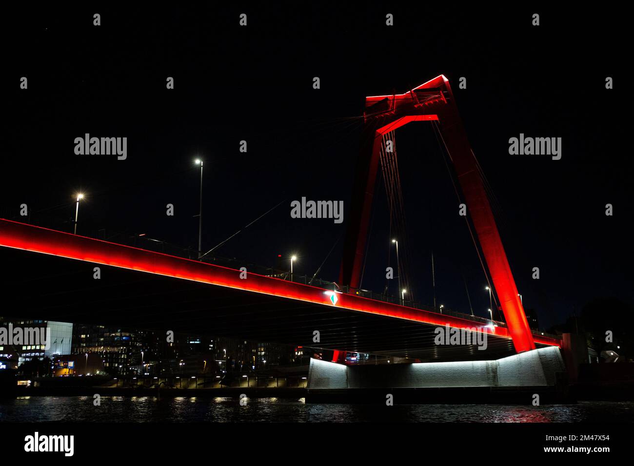 Night time urban scenery with steel draw bridge in glowing red in ...