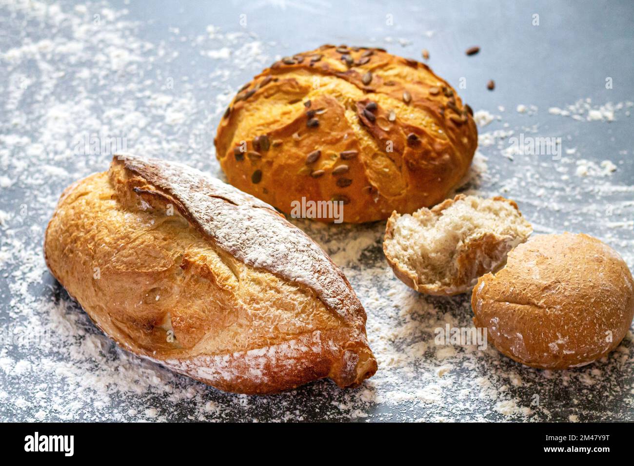 Bakery background with set of different freshly baked crispy bread and ...