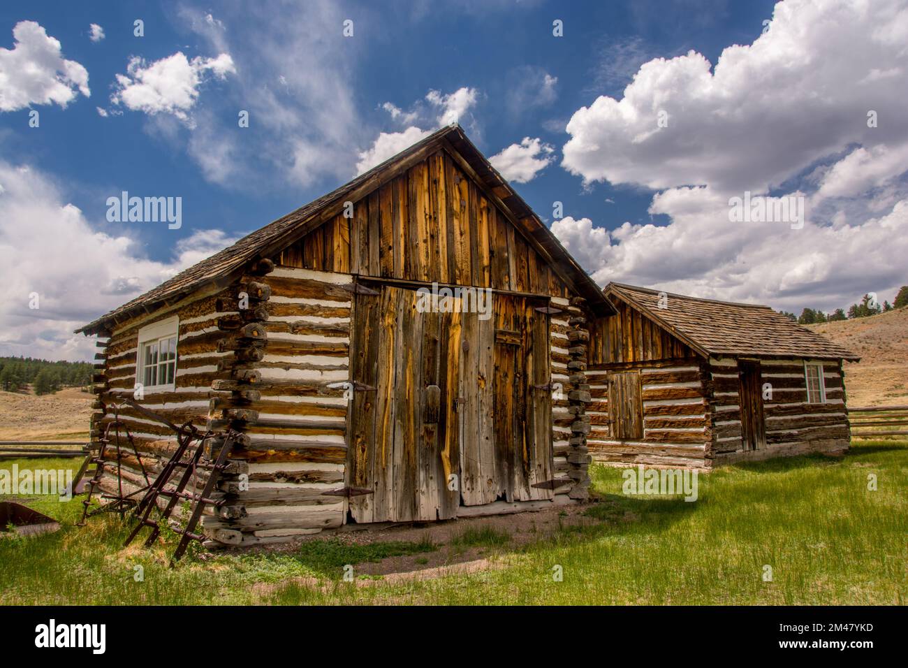 Some old log cabins standing beneath a beautiful summer sky in the ...
