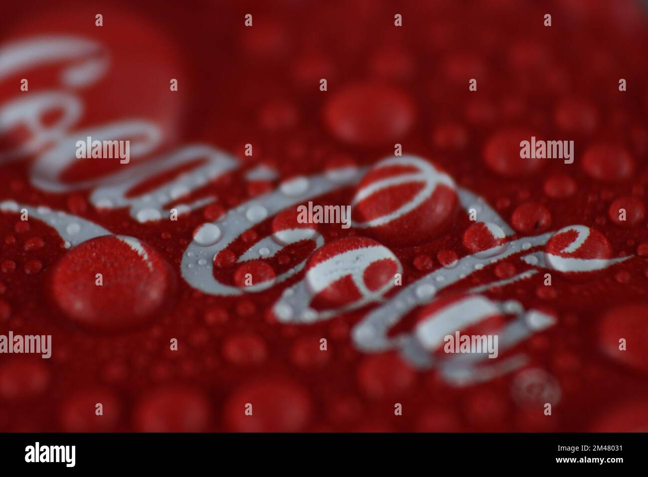 A close-up of Coca Cola white lettering on red background with fresh ...