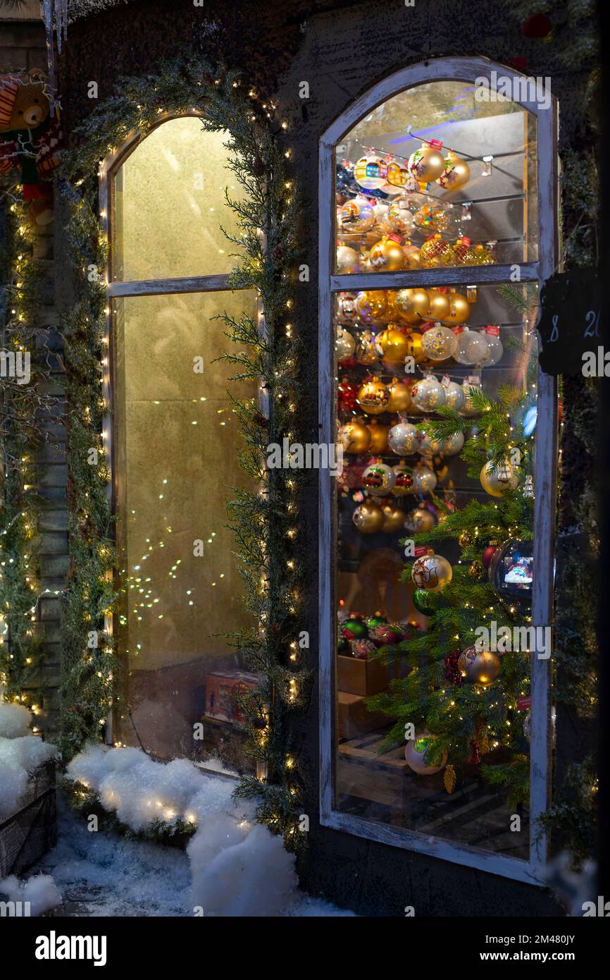 Christmas shop window with warm light, baubles, Xmas balls, New Year ...