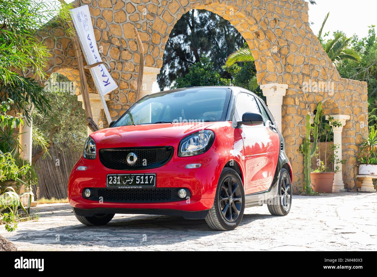 A red smart Fortwo car in the hotel parking on a beautiful sunny day ...