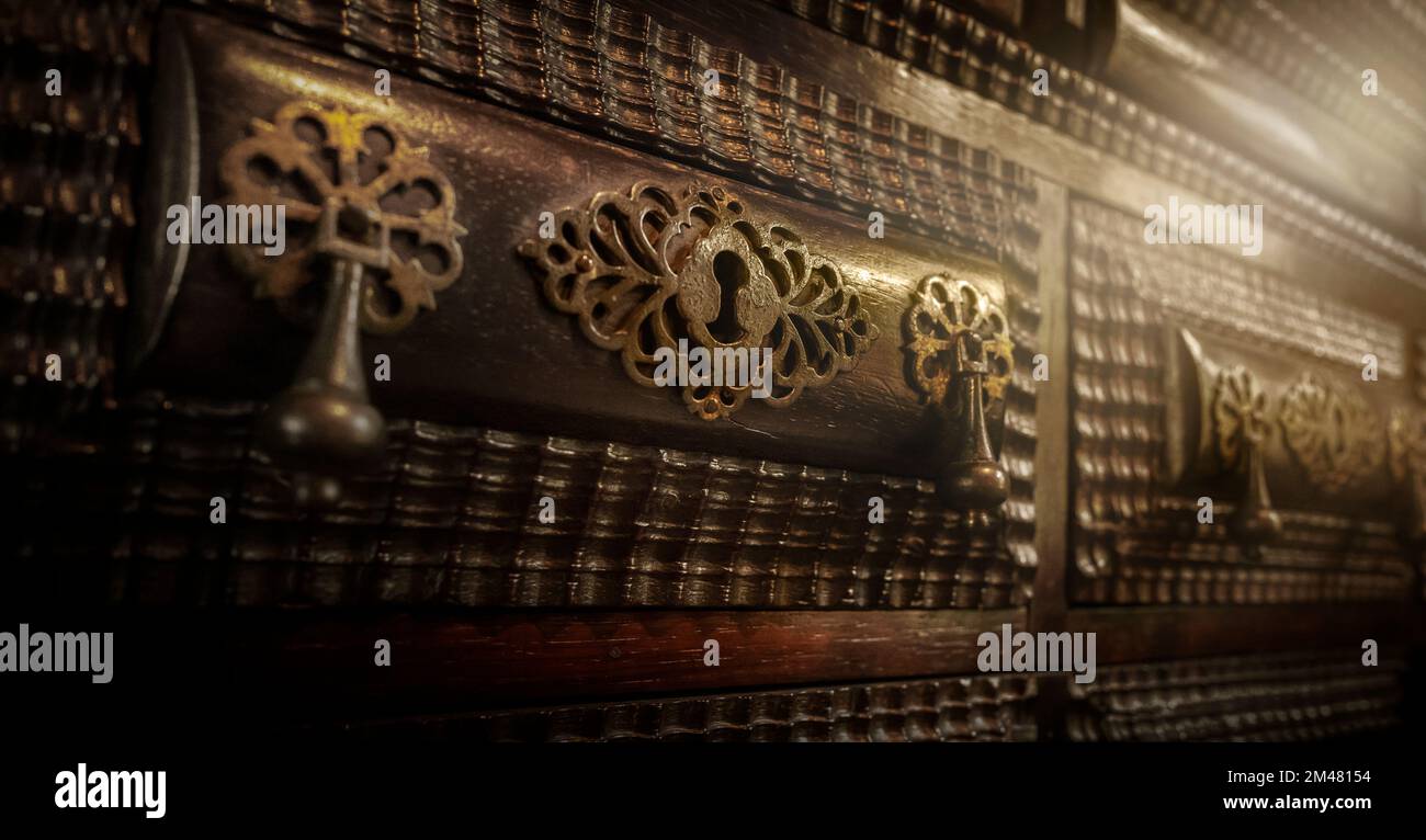 Secret drawer. Shallow focus against keyhole in ancient furniture ...