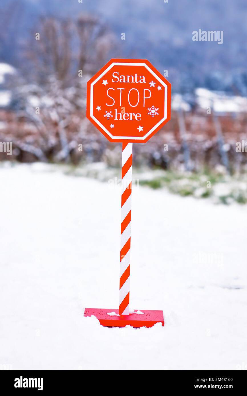 Christmas sign with text 'Santa Stop here' in snowy landscape Stock ...