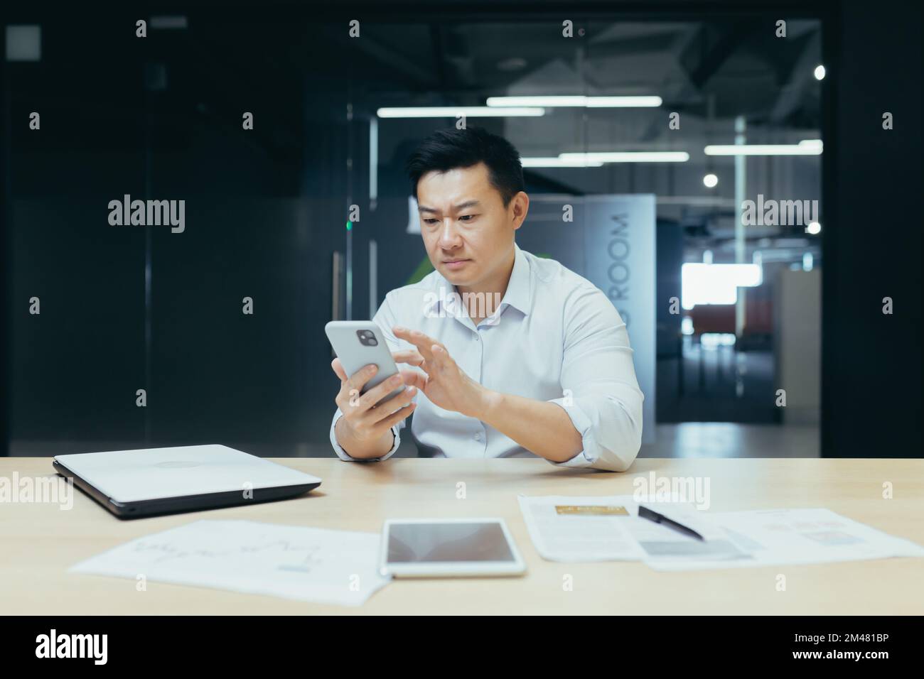 Worried young man Asian businessman sits in the office at the table ...