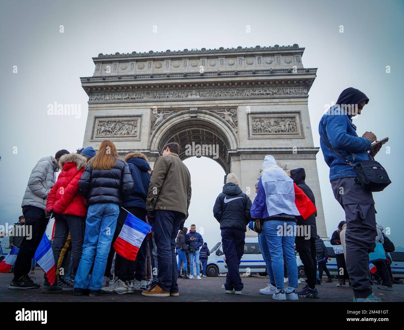 Paris, France. 18th Dec, 2022. Football fans gather under the Arc de ...