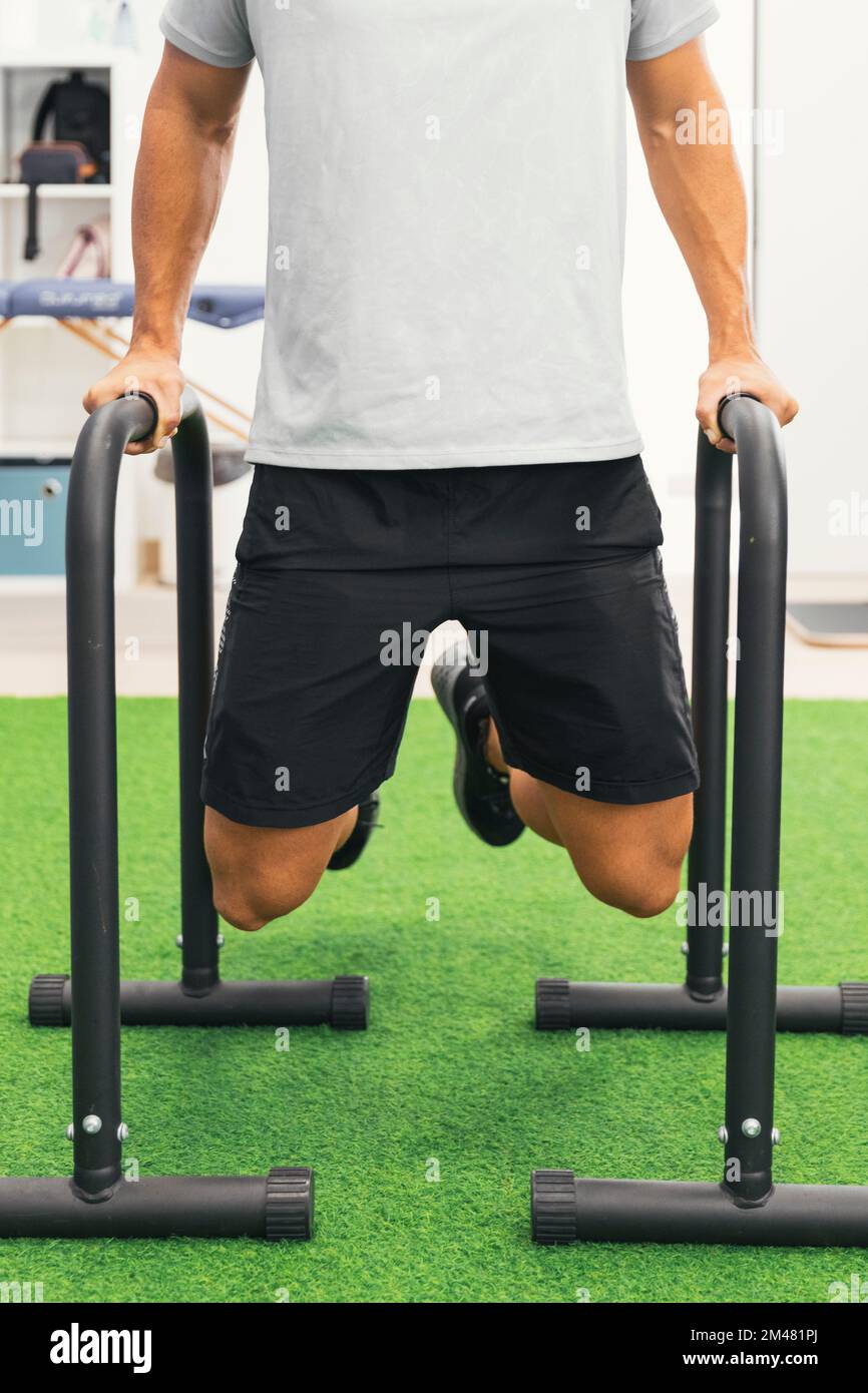 Front view photo of an unrecognizable young man exercising with bent ...