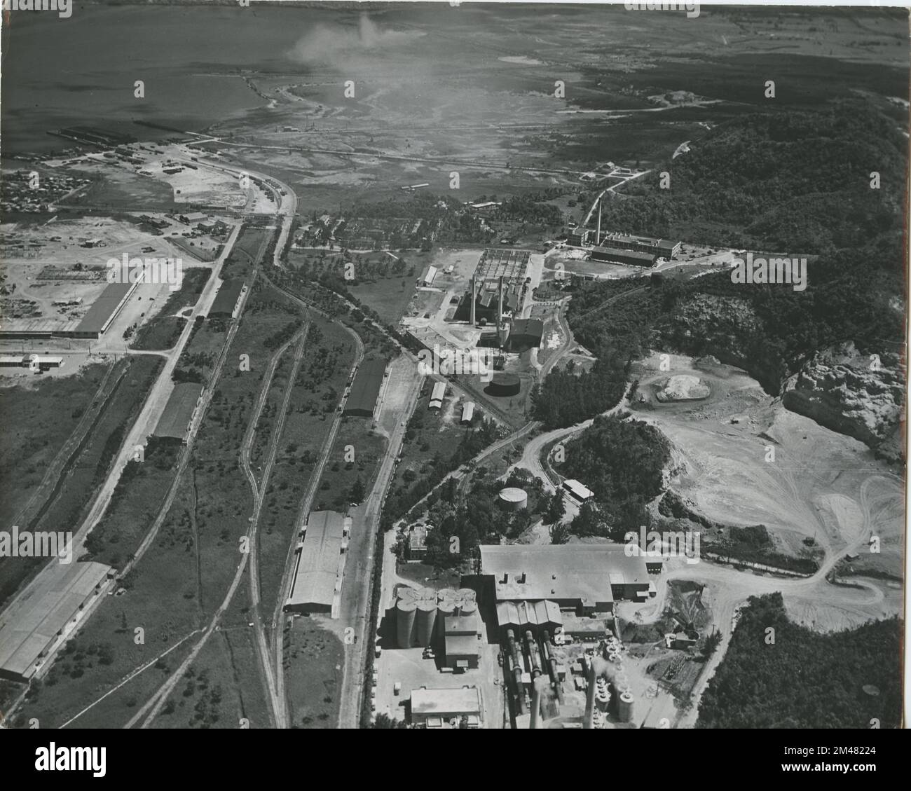 Cement, Glass, and Paper Plants. Original caption: Aerial view of ...