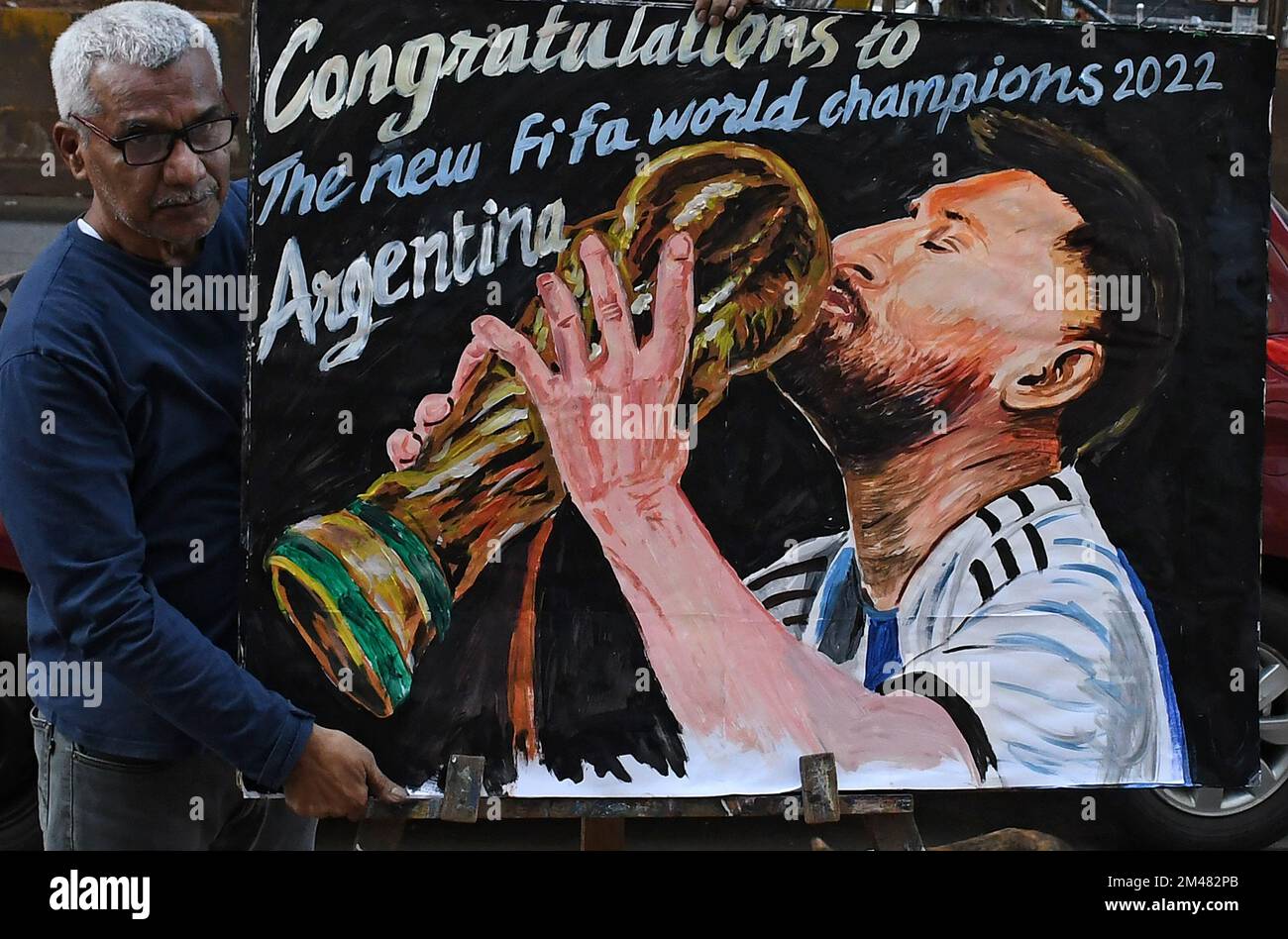 An artist from Gurukul school of art carries a painting of Lionel Messi ...