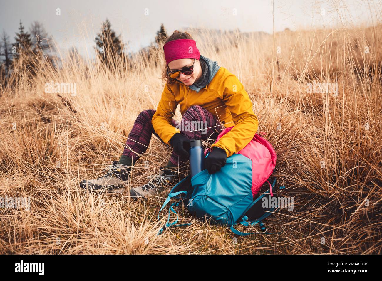 Woman blue backpack sitting hi-res stock photography and images - Alamy