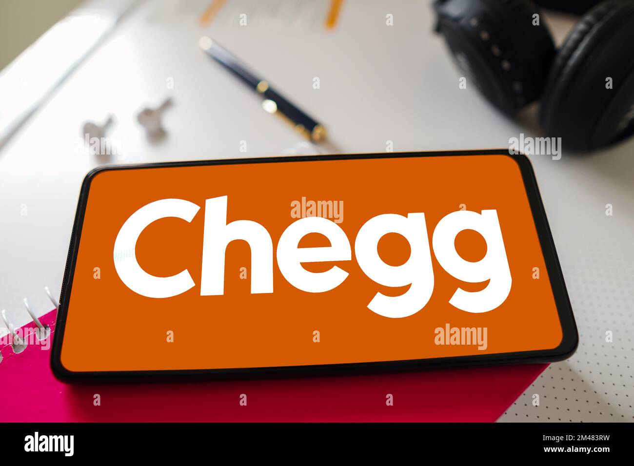 In this photo illustration, the Chegg logo is displayed on a smartphone ...