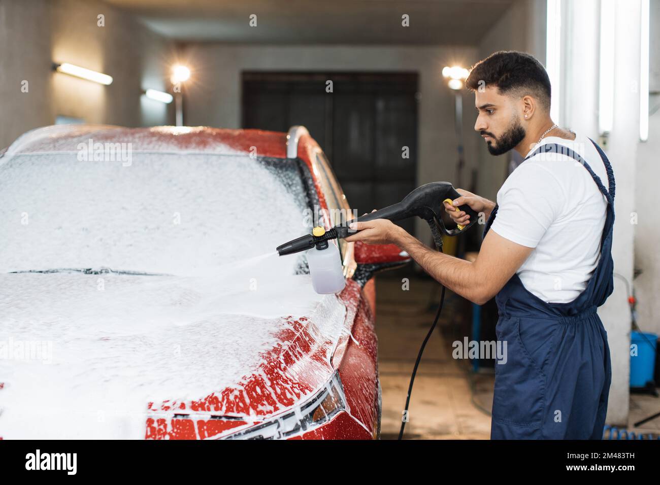 Close up portrait of car wash worker, hansome young man in protective ...