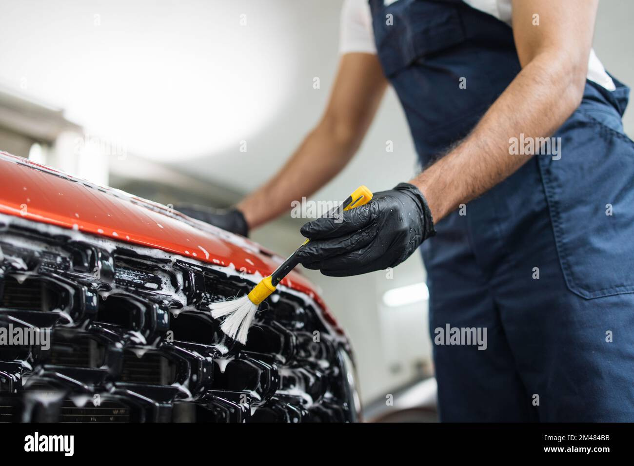 Closeup view of hand with special yellow brush of wash worker cleaning ...