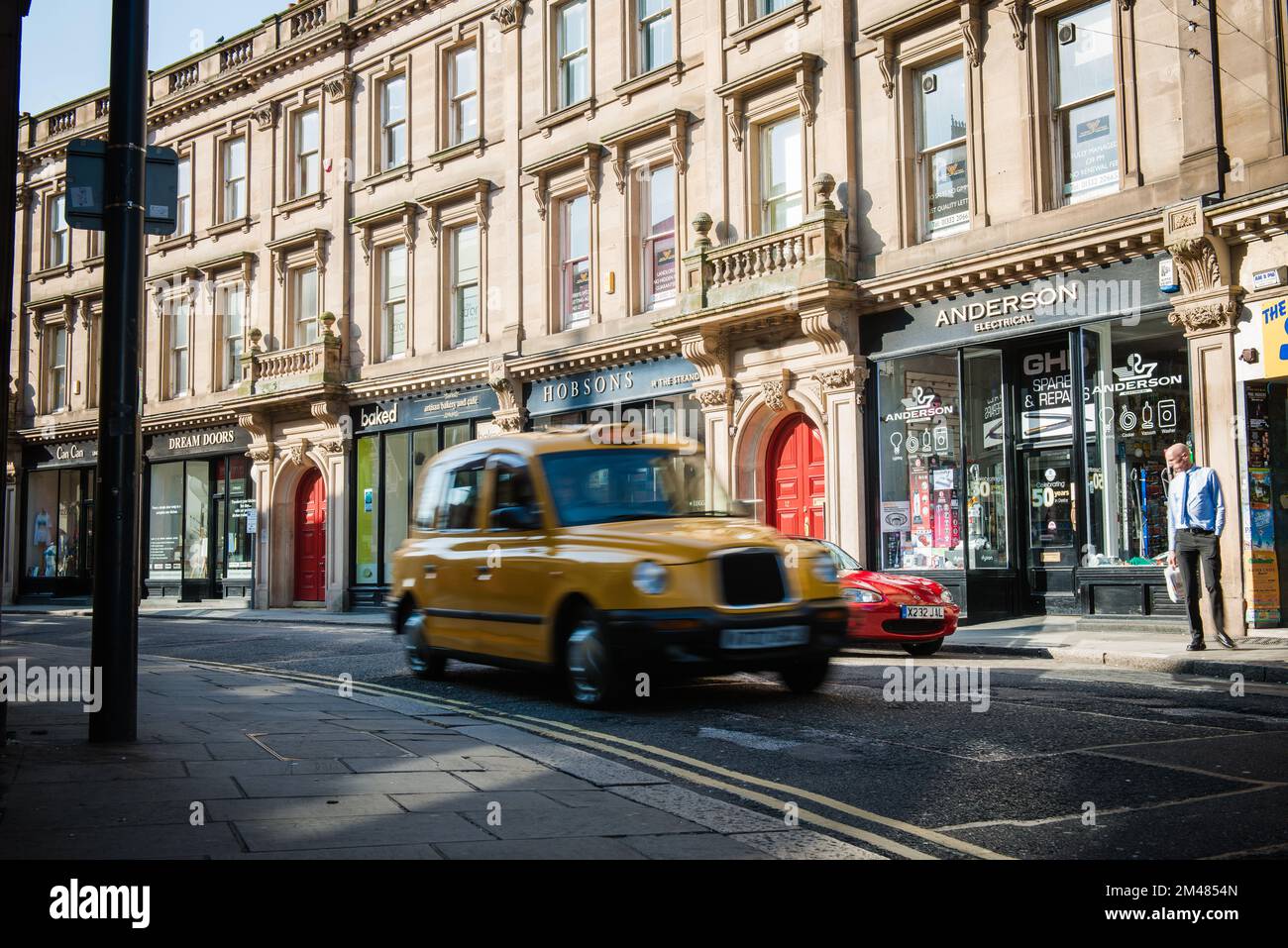 Yellow taxi on The Strand in Derby UK Stock Photo - Alamy